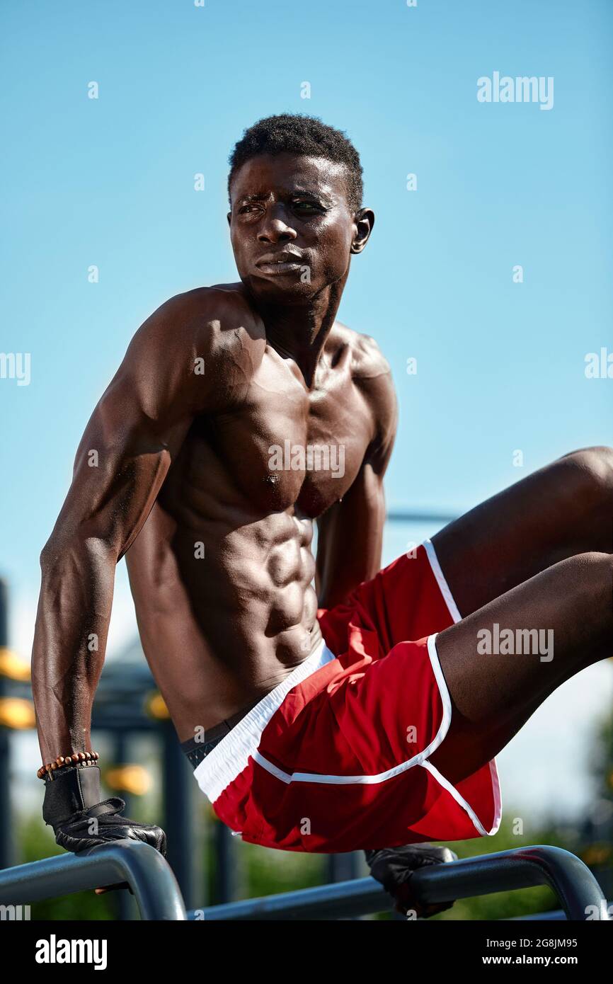 african american athlete boy does calisthenics fitness exercises on ...