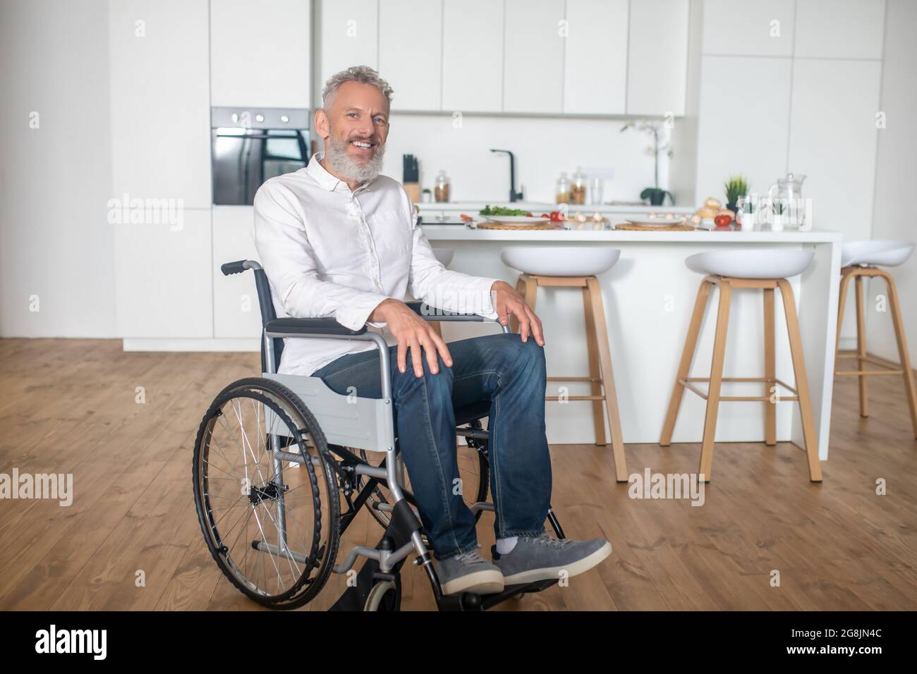 Gray-haired mature handicapped man in the kicthen Stock Photo - Alamy