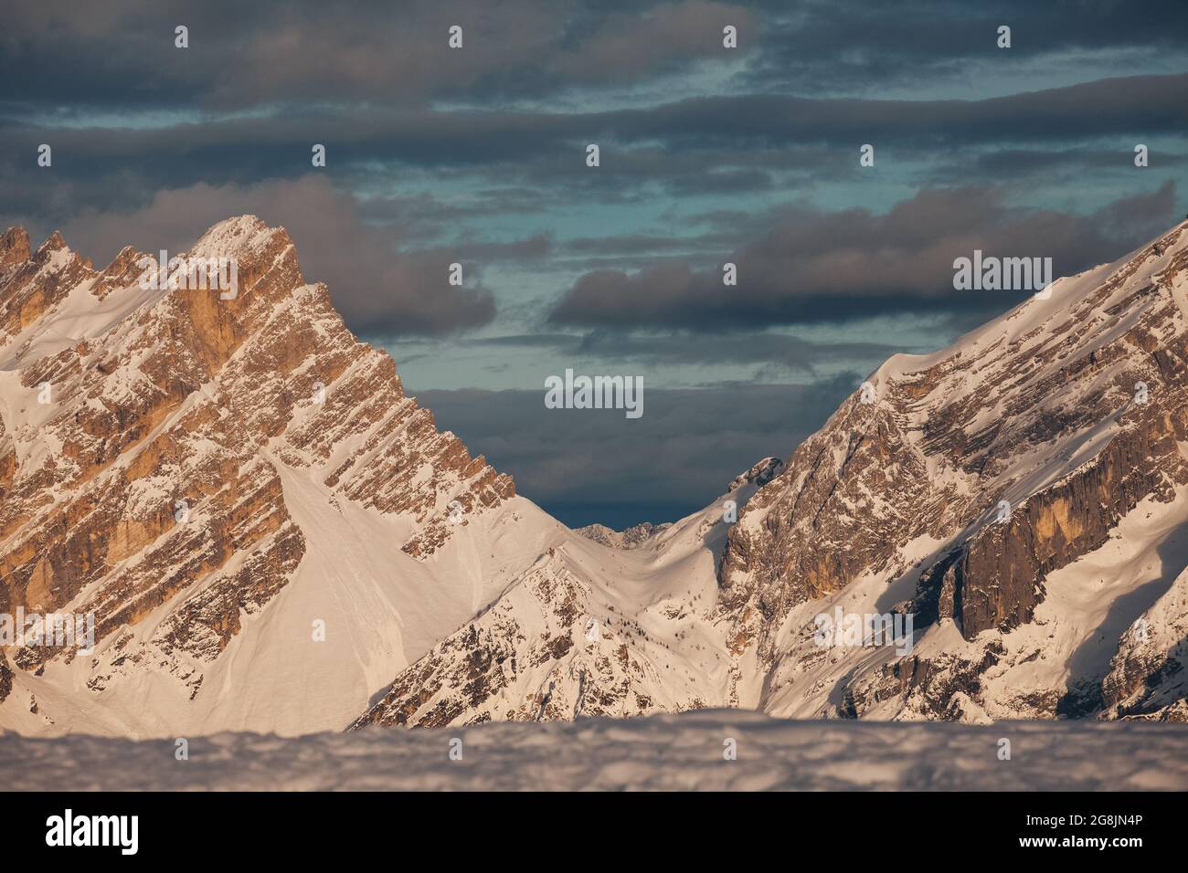 The Forcella Piccola Pass at sunset with small avalanches Stock Photo ...
