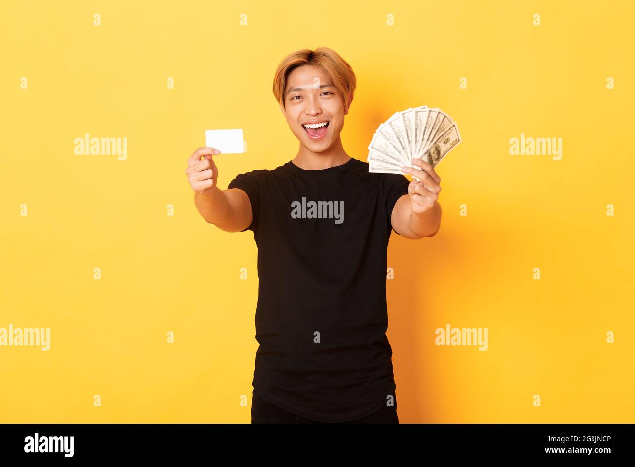 Happy good-looking asian guy in black casual clothes, showing money and ...