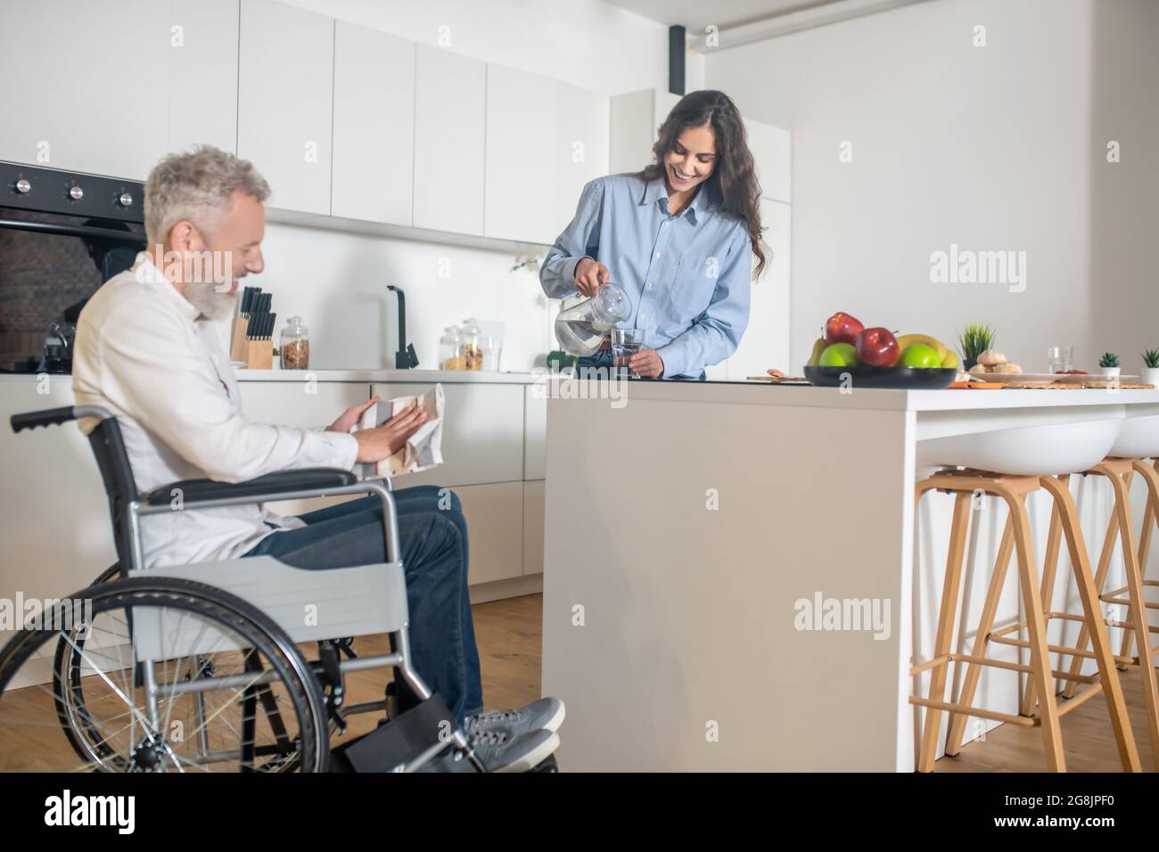Gray-haired handicapped man and his wife at home before breakfast Stock ...
