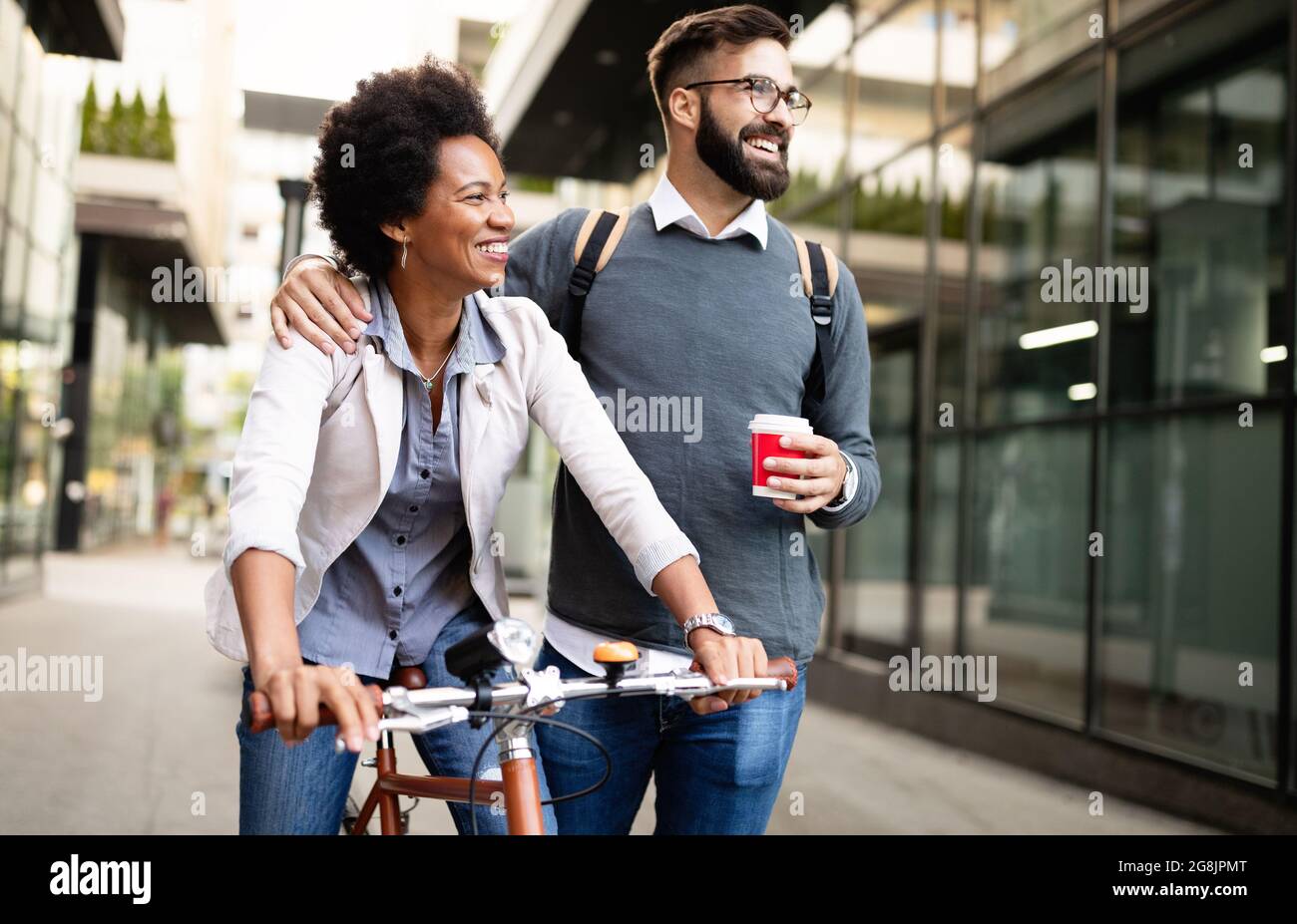 Cheerful people going for a bike ride. Happy couple having fun in the ...