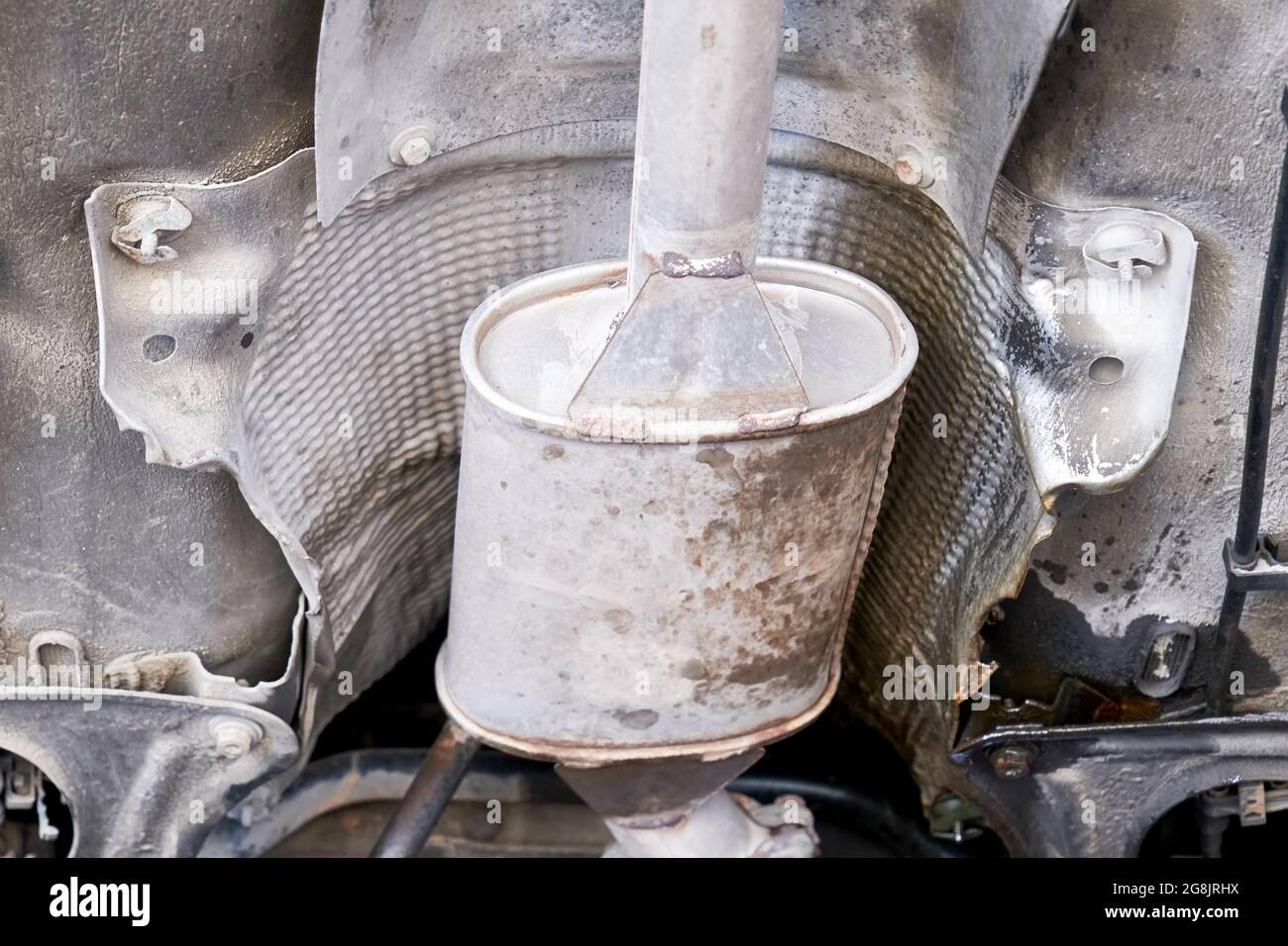 Old, worn and rusty exhaust system of a lifted car. View from below ...
