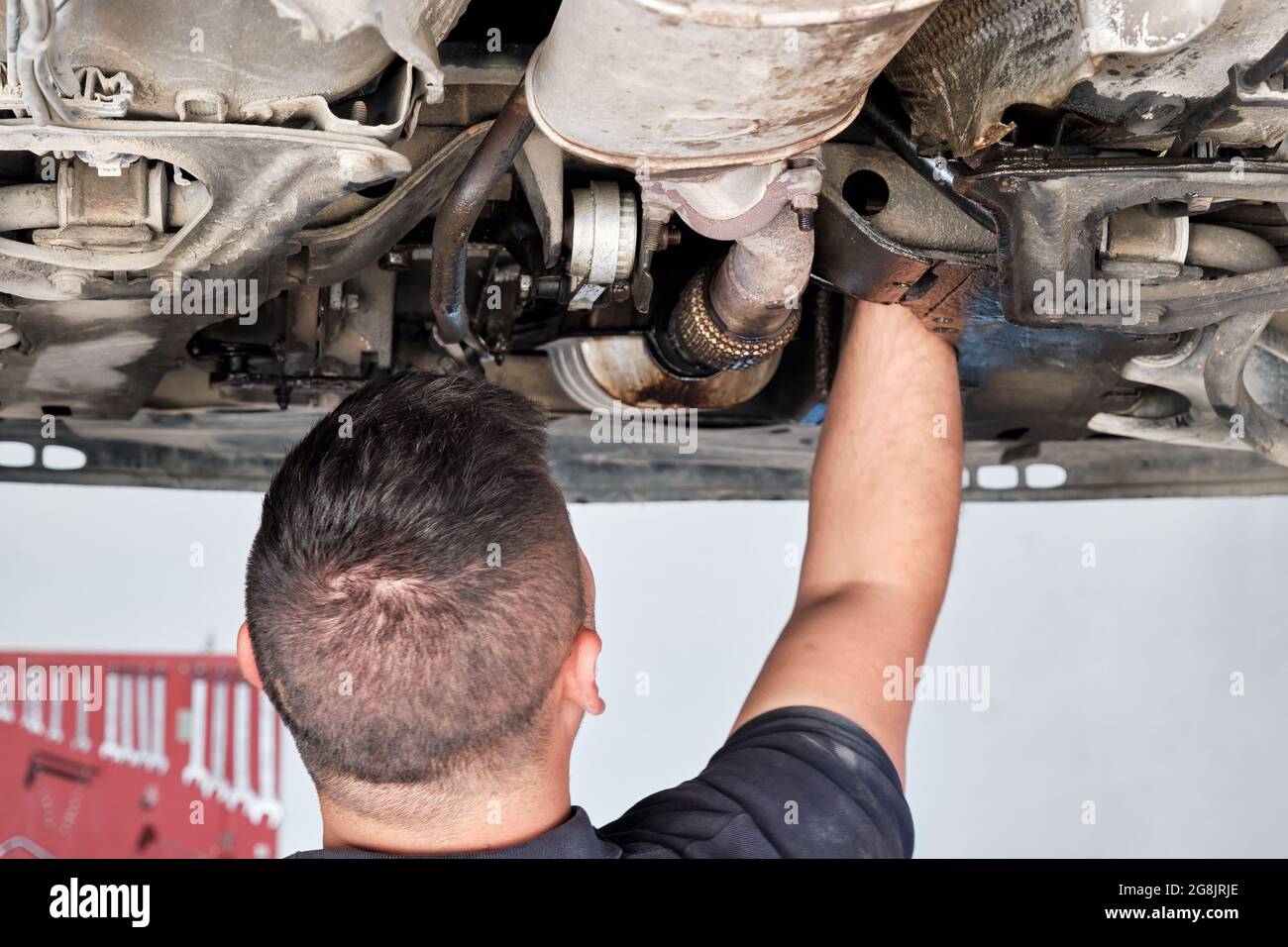 Mechanic checking a car on the lift at the auto repair service station ...