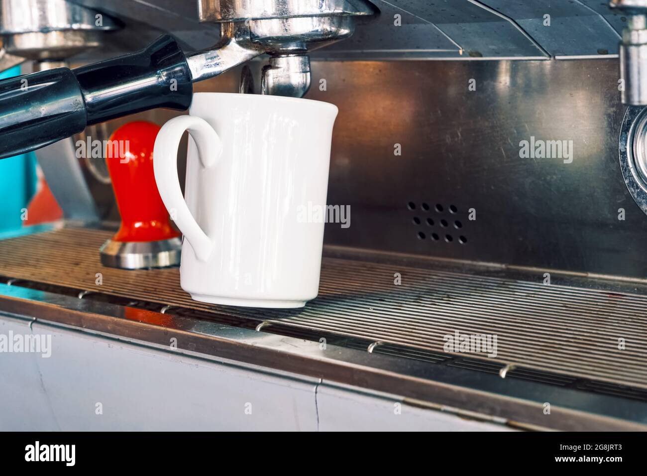 Professional hot steam coffee machine filling a white mug Stock Photo ...