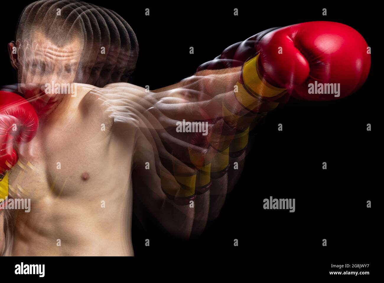 Close-up portrait of young professional male boxer in motion exercising ...