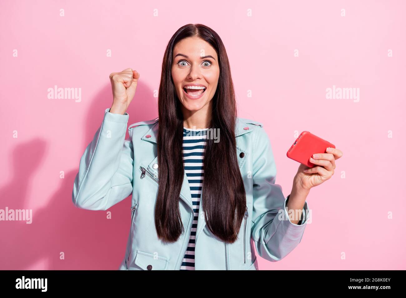 Photo of brunette victorious woman raise fist celebrate win video game ...