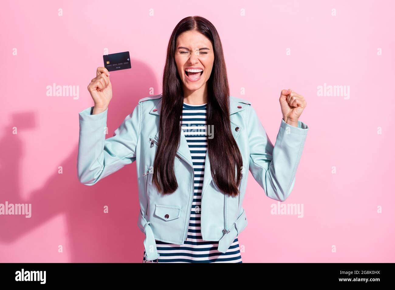 Photo of triumphant happy charming woman celebrate win hold plastic ...