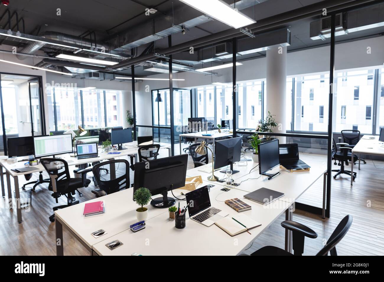 Interior of empty modern office with desks and computers Stock Photo ...