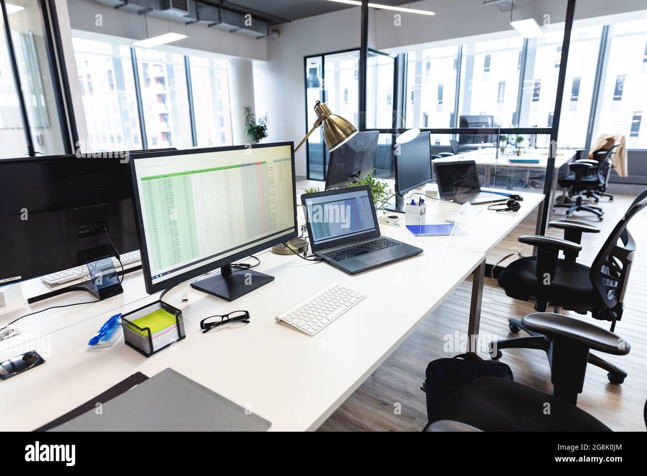Interior of empty modern office with desks and computers Stock Photo ...