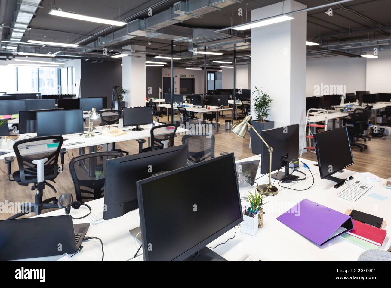 Interior of empty modern office with desks and computers Stock Photo ...