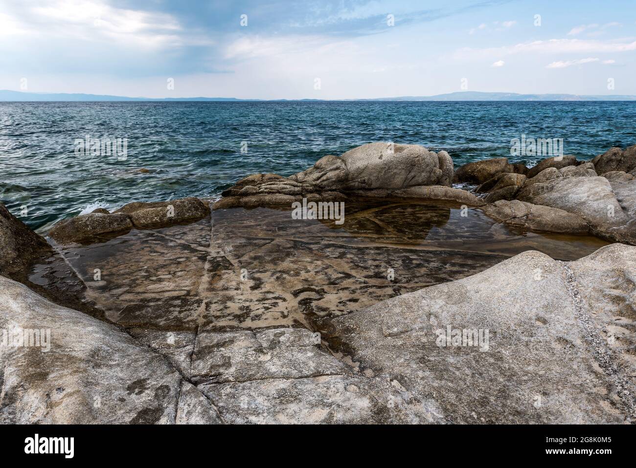 Natural sea water pond in a rock - Aegean sea coast landscape with ...