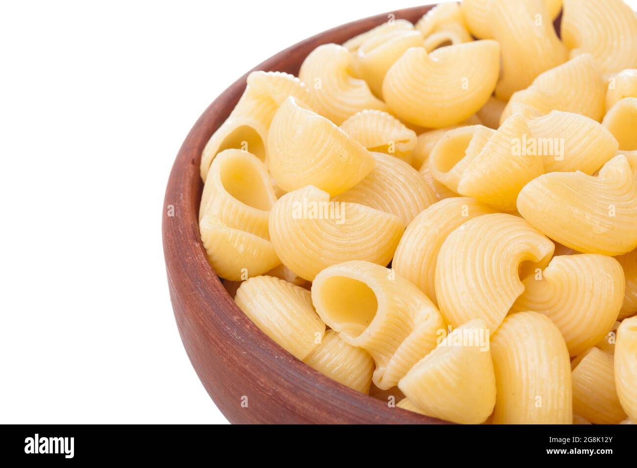 shell pasta in bowl, isolated on white background Stock Photo - Alamy