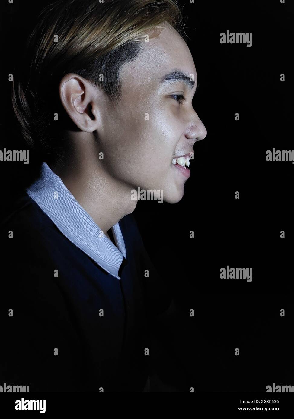 A Smiling Asian Man Side Profile Stock Photo - Alamy