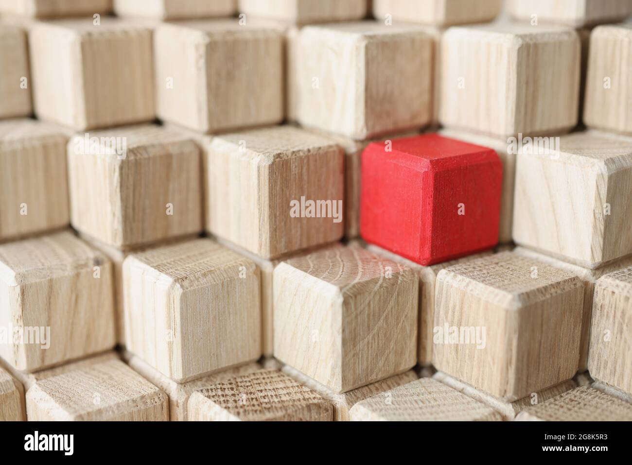 Wooden cubes of beige color in middle of red stands in pyramid Stock ...