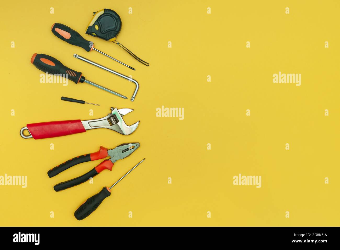 tools on isolated yellow background Stock Photo - Alamy