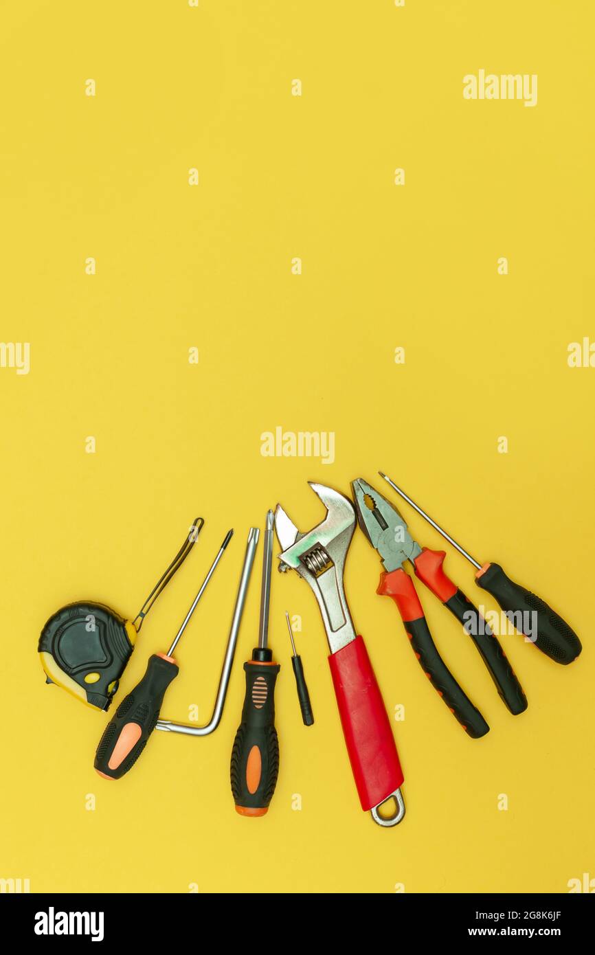 tools on isolated yellow background Stock Photo - Alamy