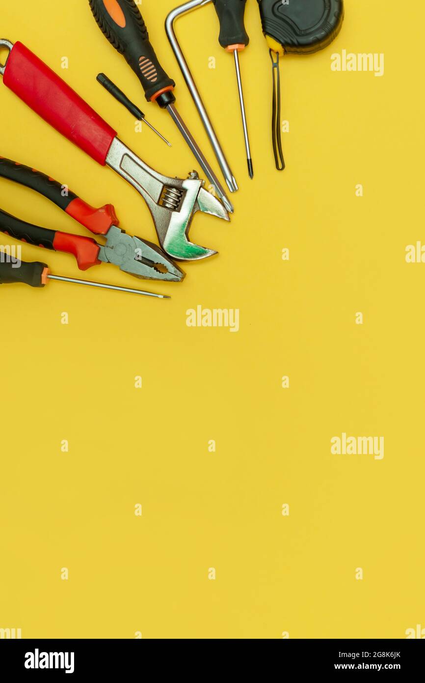 tools on isolated yellow background Stock Photo - Alamy
