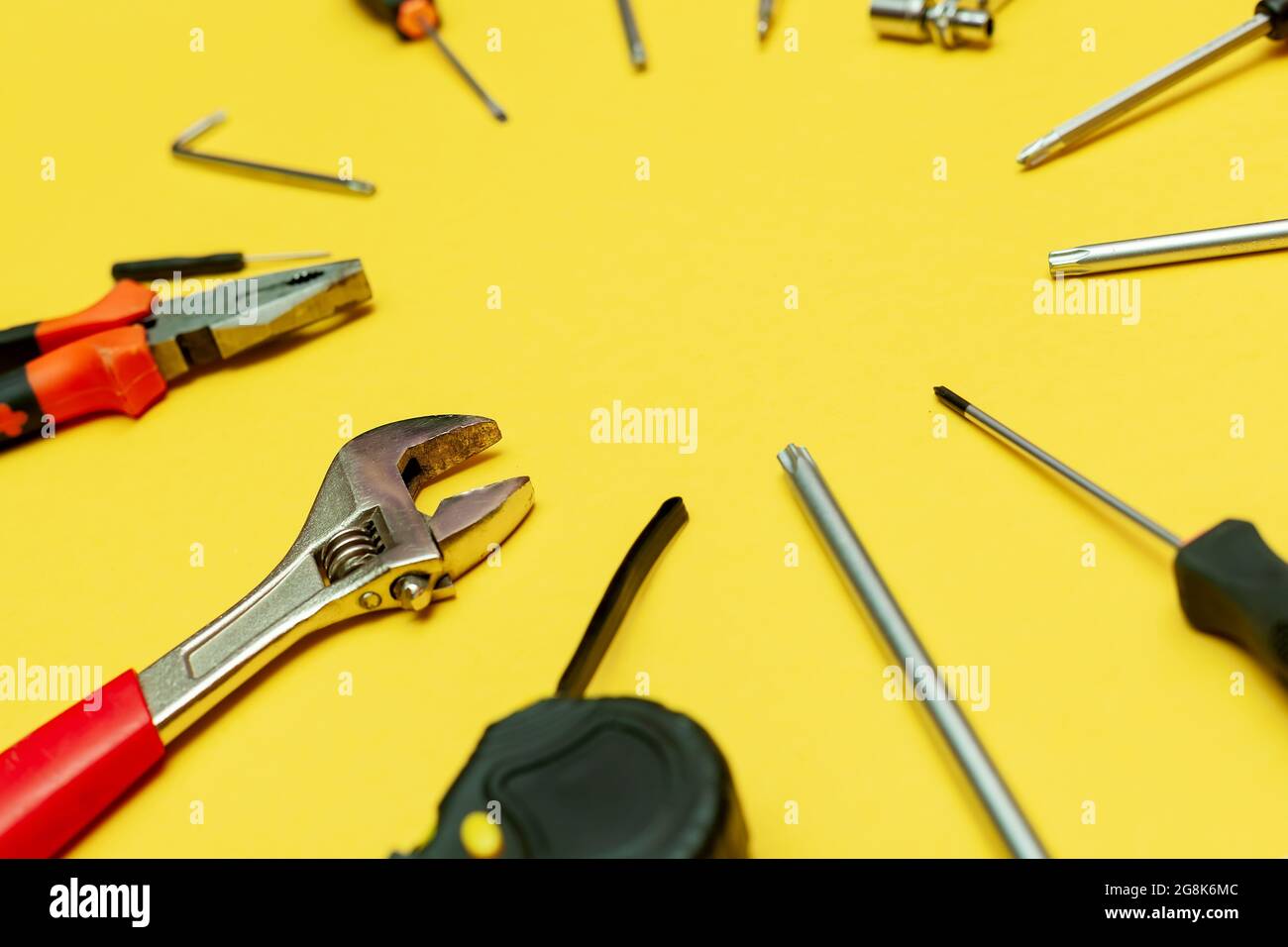 tools on isolated yellow background Stock Photo - Alamy
