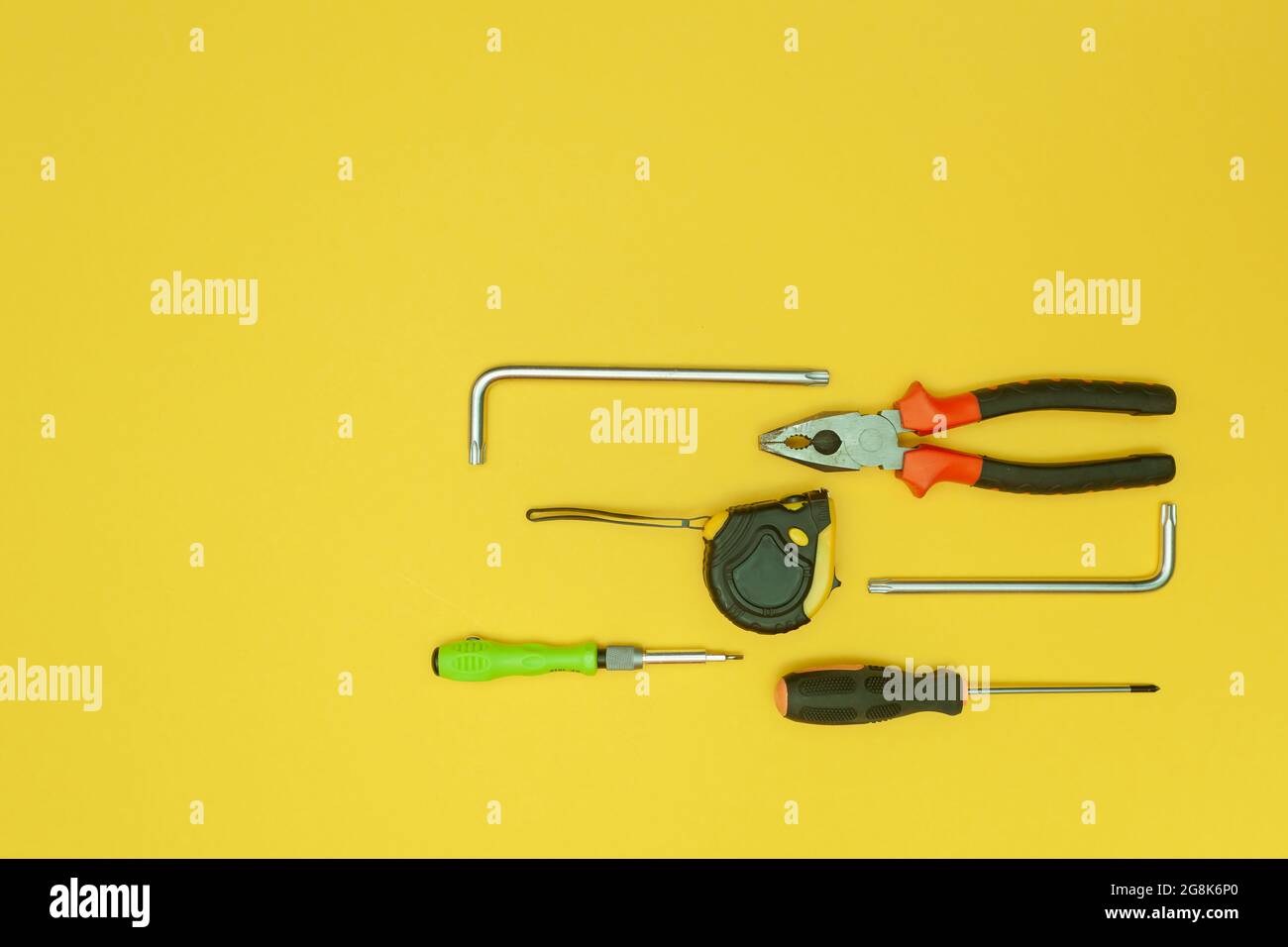 tools on isolated yellow background Stock Photo - Alamy