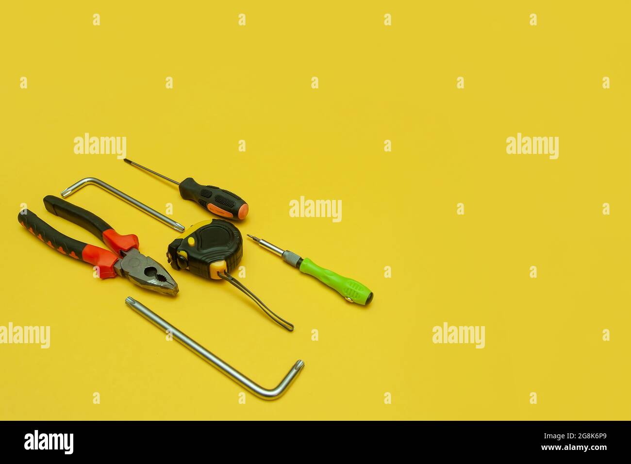 tools on isolated yellow background Stock Photo - Alamy