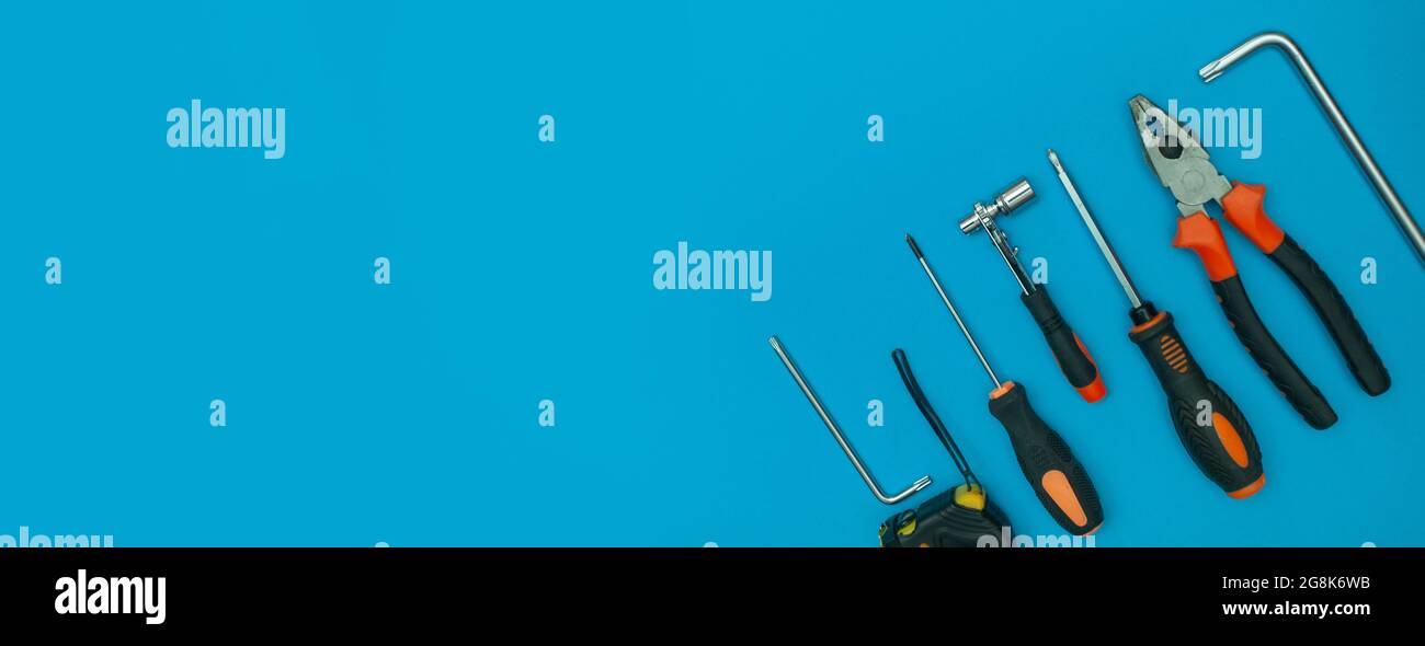 tools on isolated blue background panorama Stock Photo - Alamy