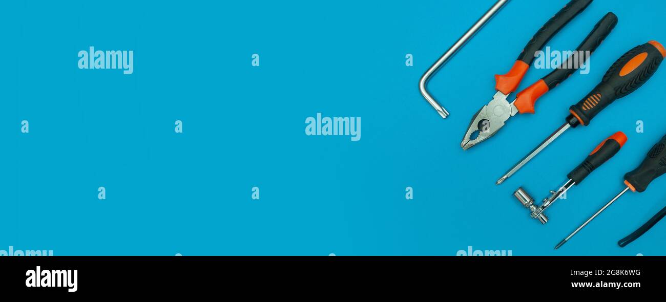 tools on isolated blue background panorama Stock Photo - Alamy
