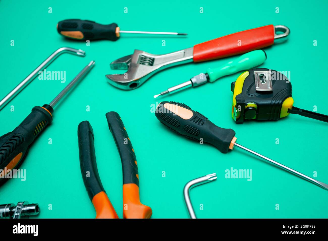 tools on isolated green background Stock Photo - Alamy