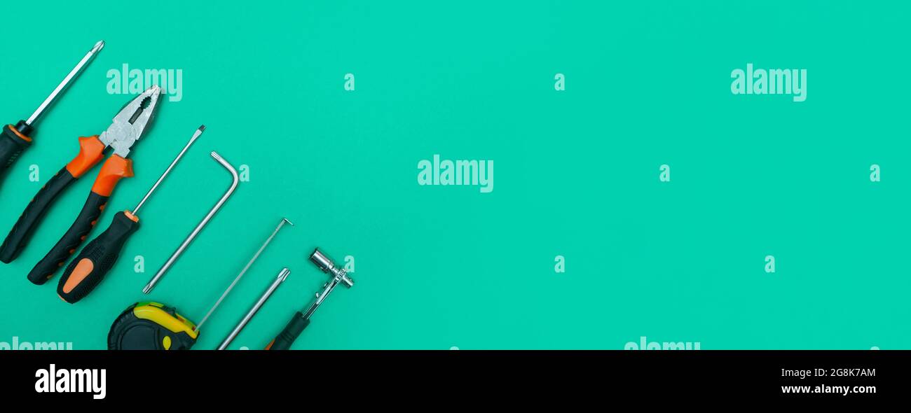 tools on isolated green background panorama Stock Photo - Alamy