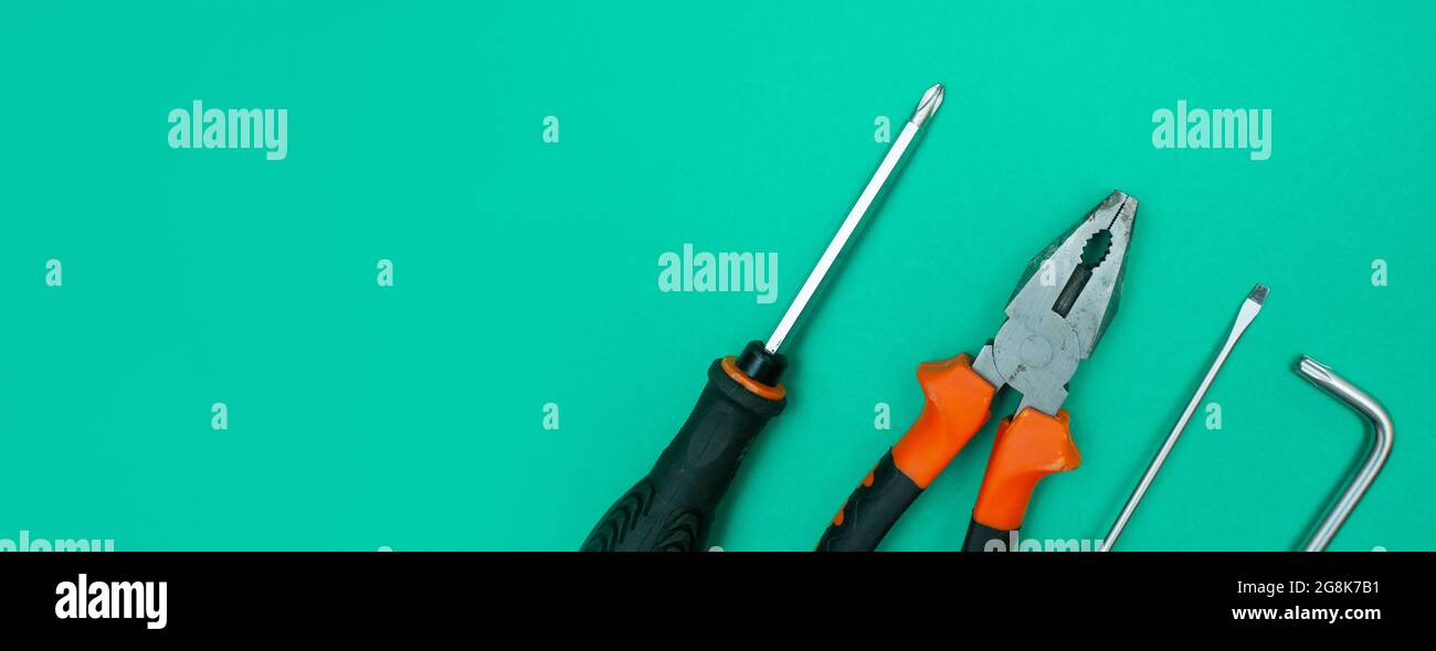 tools on isolated green background panorama Stock Photo - Alamy