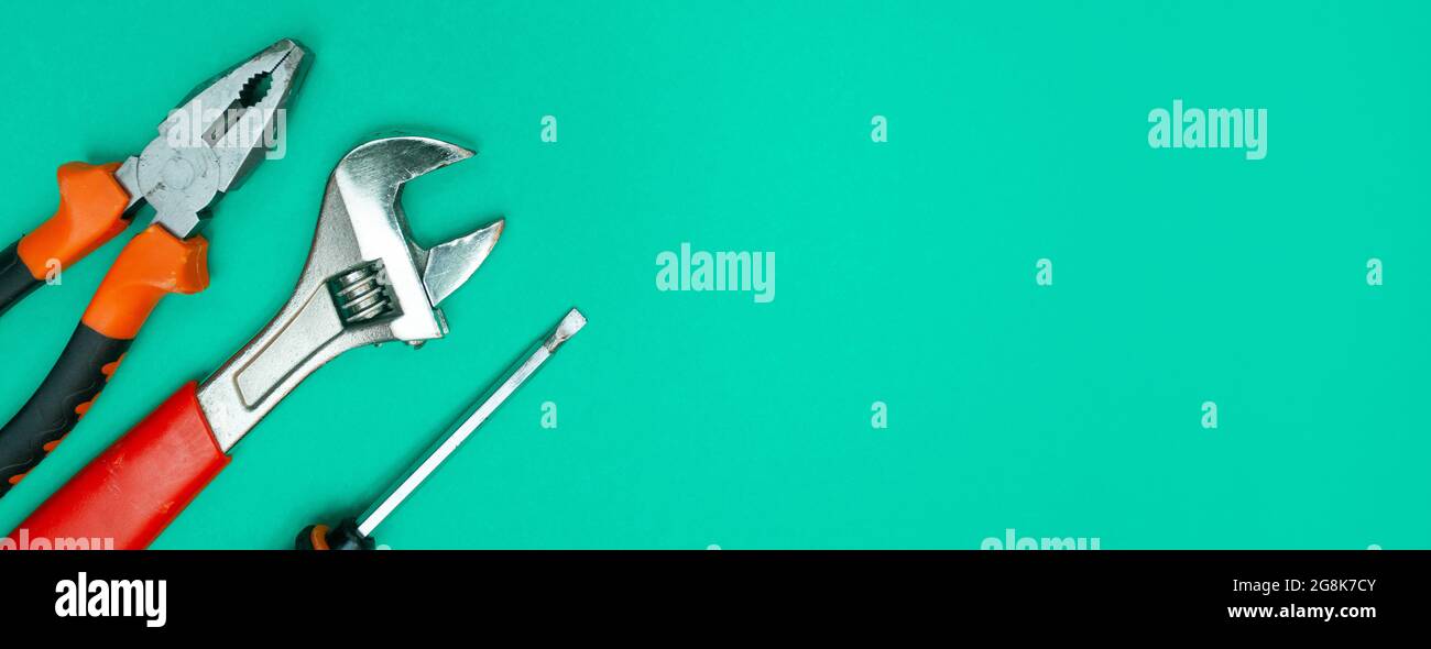 tools on isolated green background panorama Stock Photo - Alamy