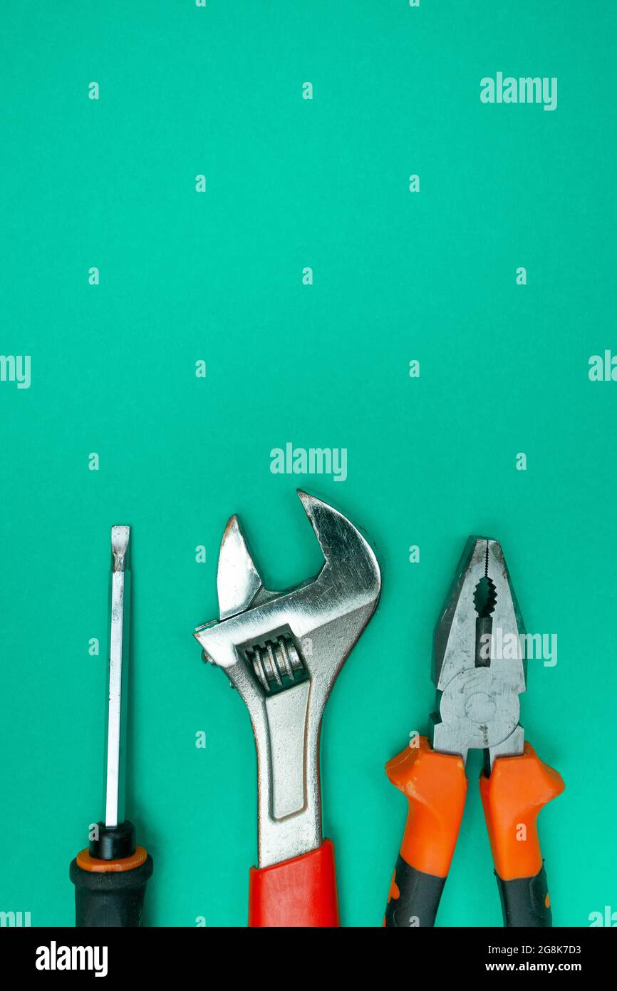 tools on isolated green background Stock Photo - Alamy