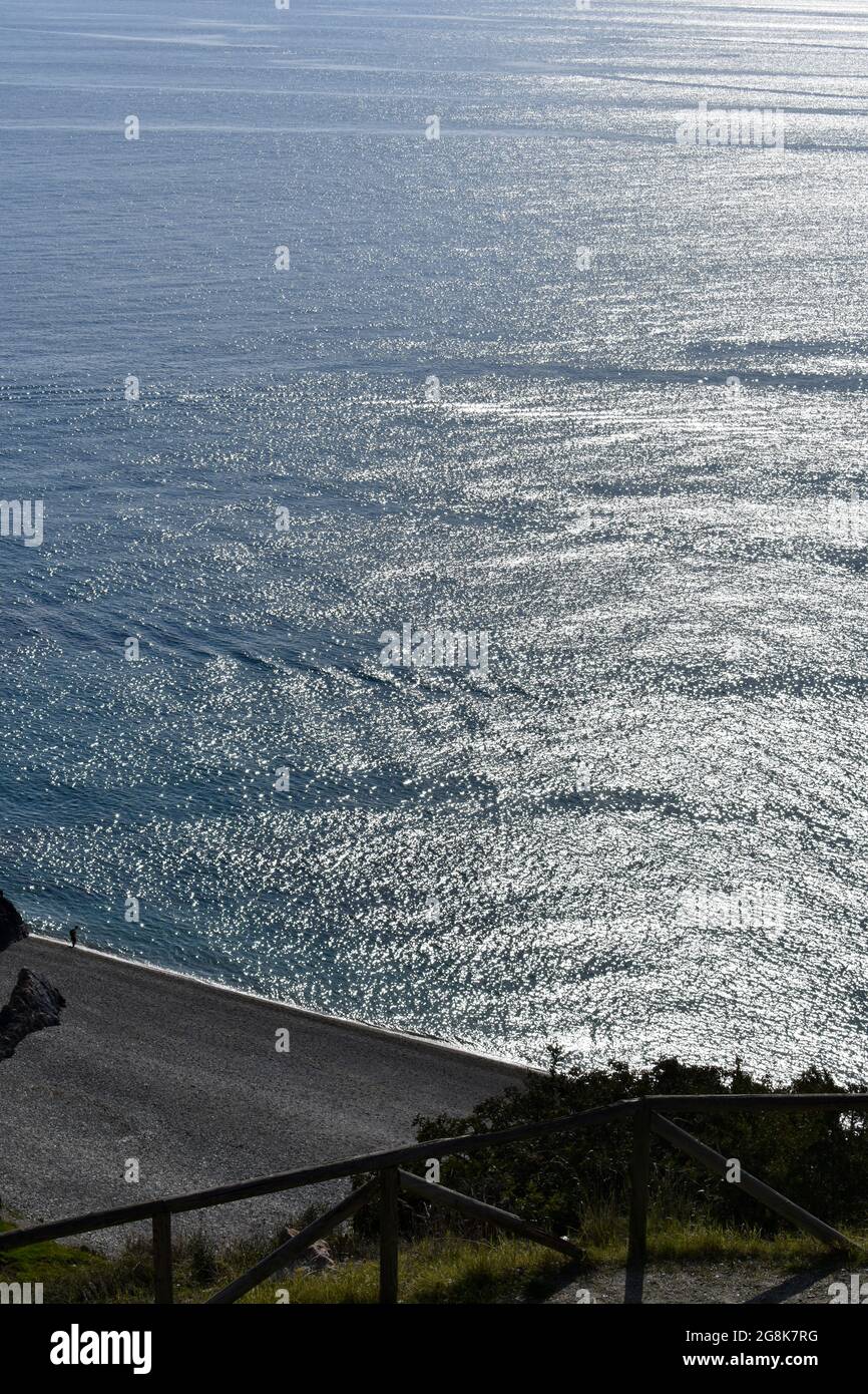 Remote beach, Spain Secluded sandy shore in a dramatic rocky cove ...