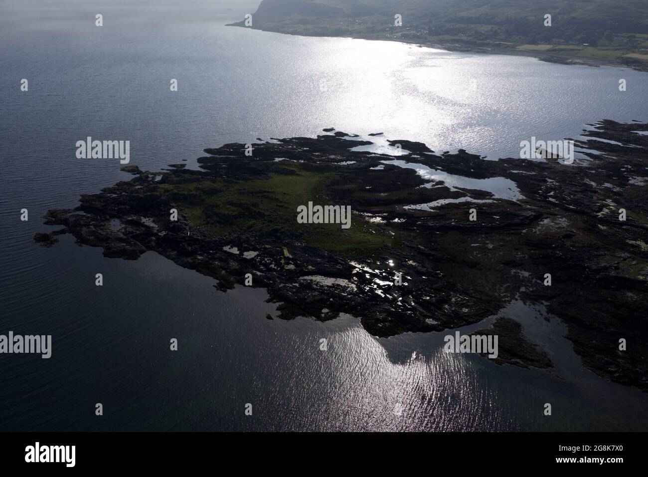 Aerial view of a small rock peninsula at sunset Stock Photo - Alamy