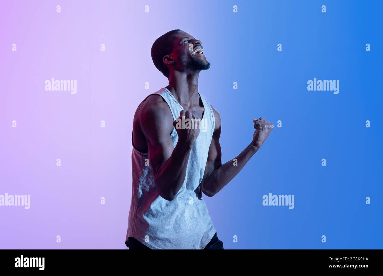 Excited young African American athlete feeling triumphant, celebrating ...