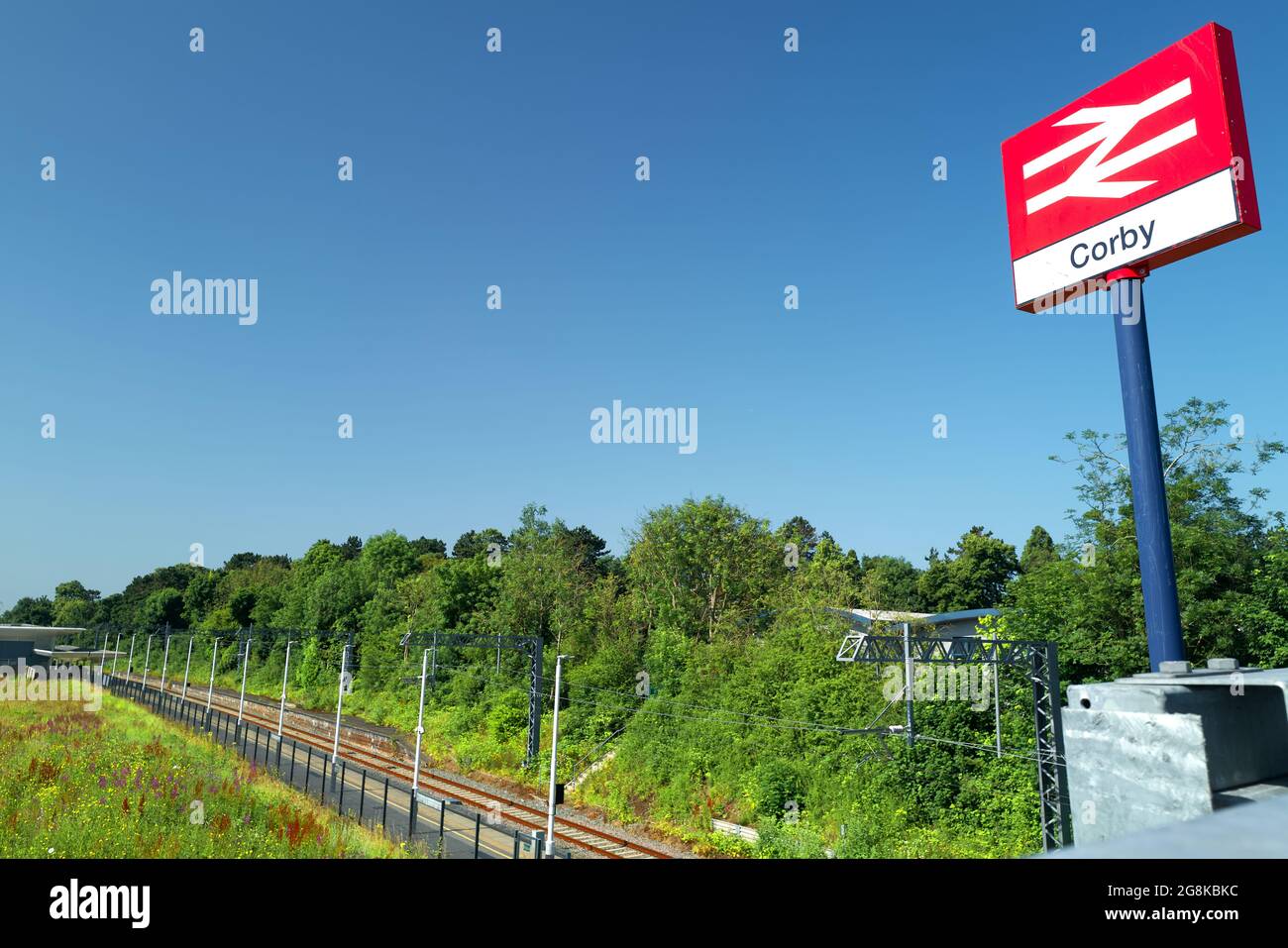 Sign above the railway track and station at Corby, England Stock Photo ...