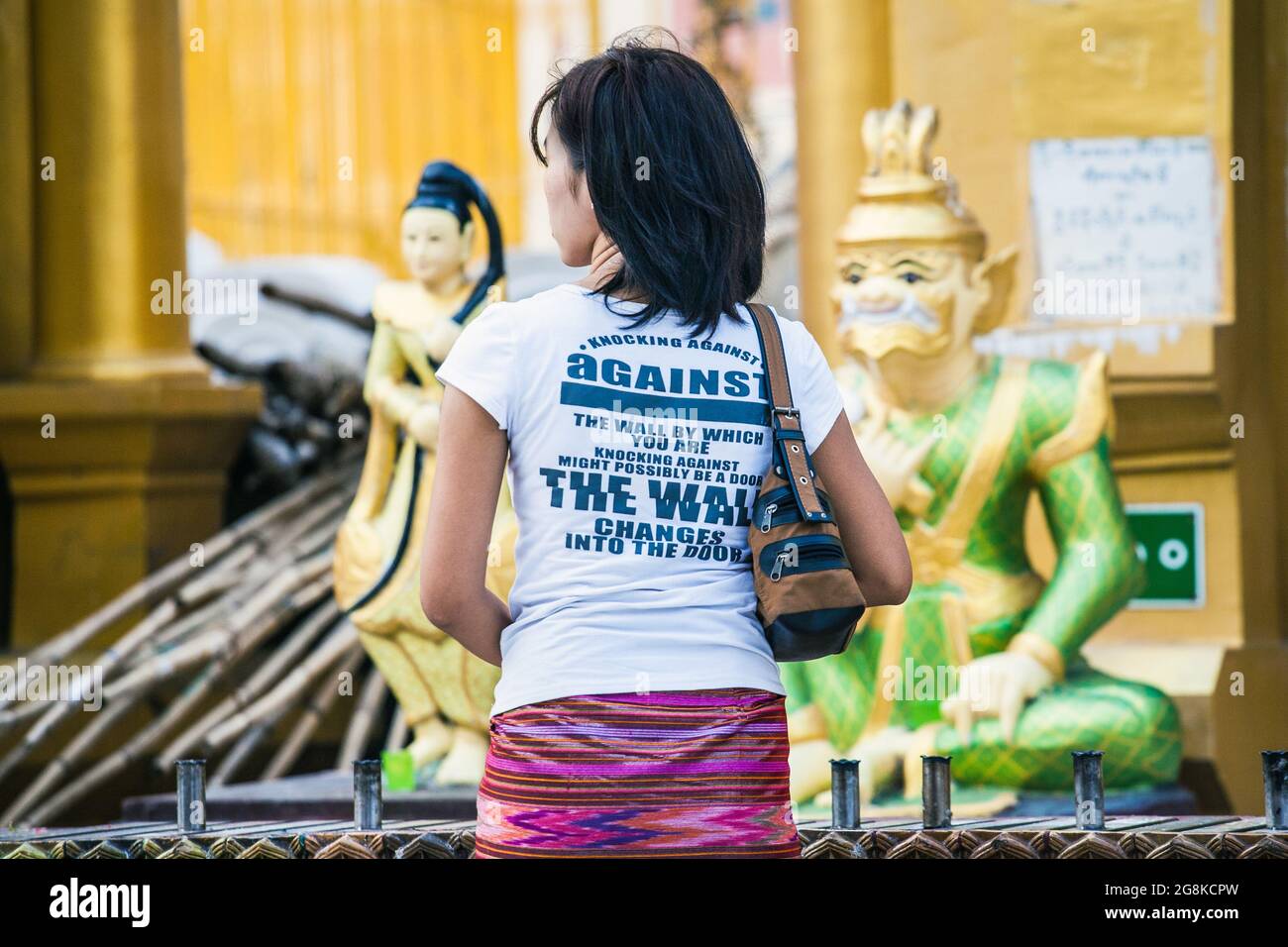 Rear view of Burmese female with short hair wearing inspirational ...