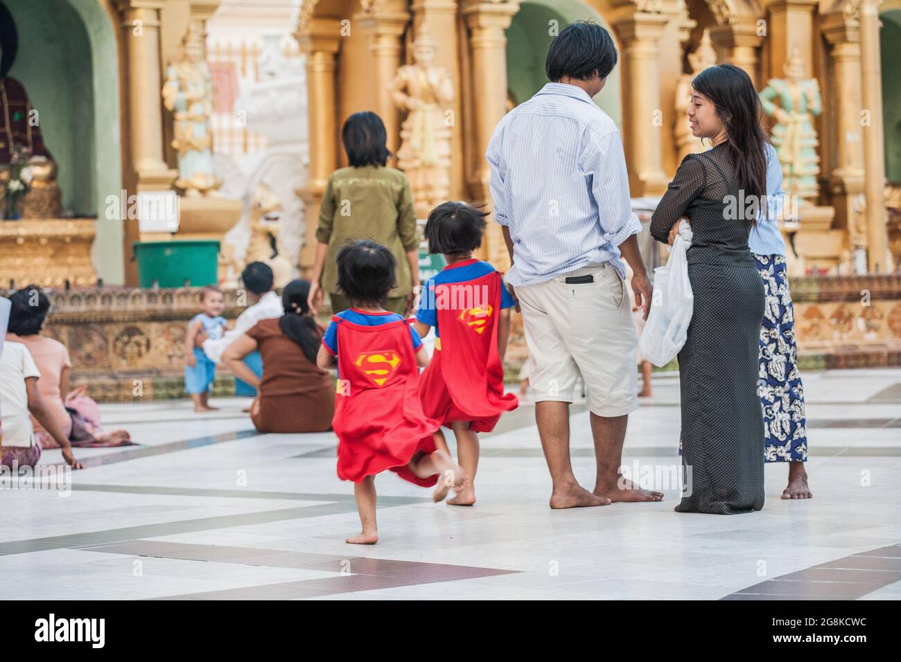 Young Burmese children run around dressed as Superhero Superman wearing ...