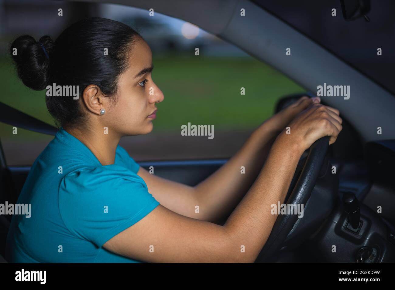 Young concentrated Hispanic female driving her car Stock Photo - Alamy