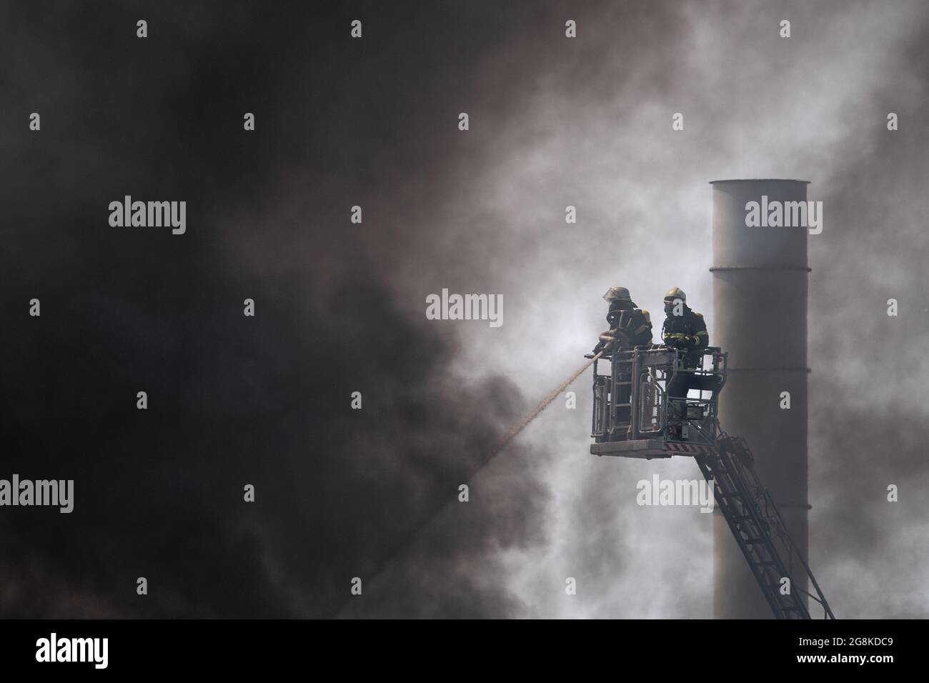 Erftstadt, Germany. 21st July, 2021. Firefighters fight a fire in a ...