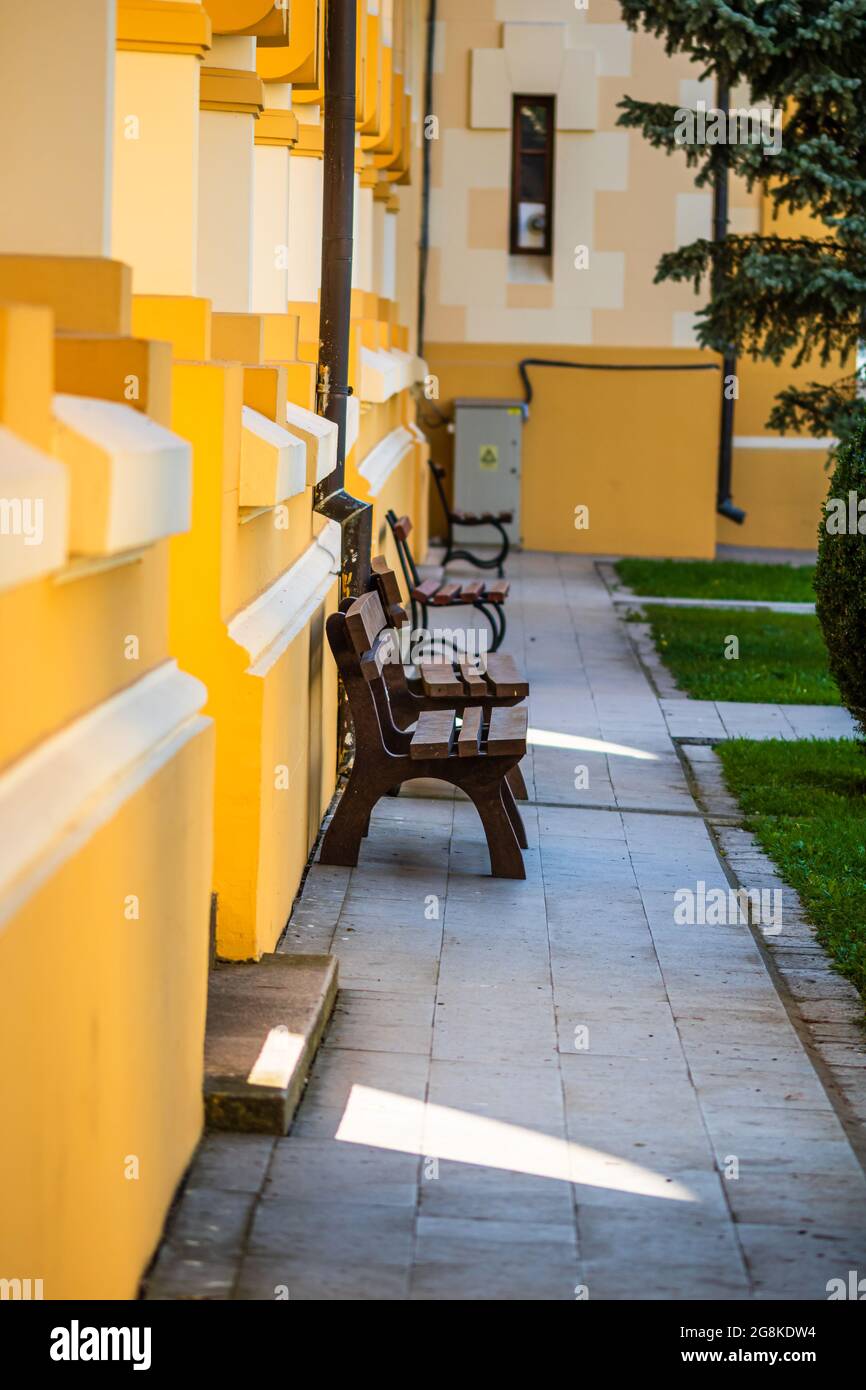 Elegant facade building and benches on the alley Stock Photo - Alamy