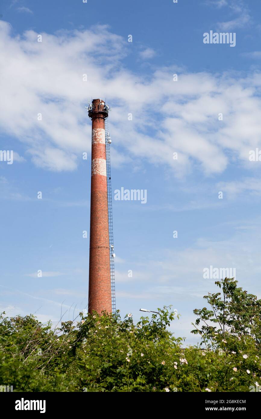 Factory chimney in industrial zone Stock Photo - Alamy