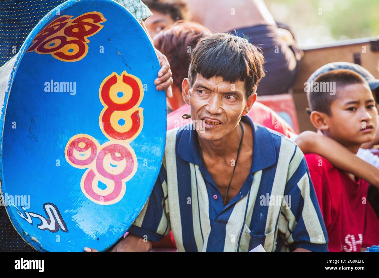 Close up portrait of middle aged Burmese male leaning on speaker system ...