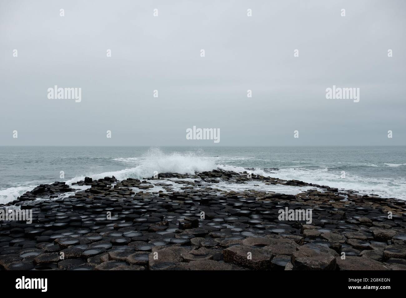 View of sea waves rushing into the rocky shore, Giant's Causeway in ...