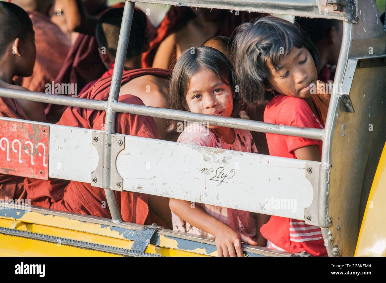 Cute young Burmese girl wearing thanaka face powder looking out from ...