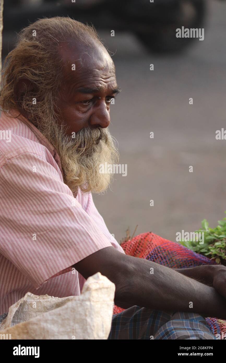 Old man sad face, he is sitting in road side. Thinking something else ...
