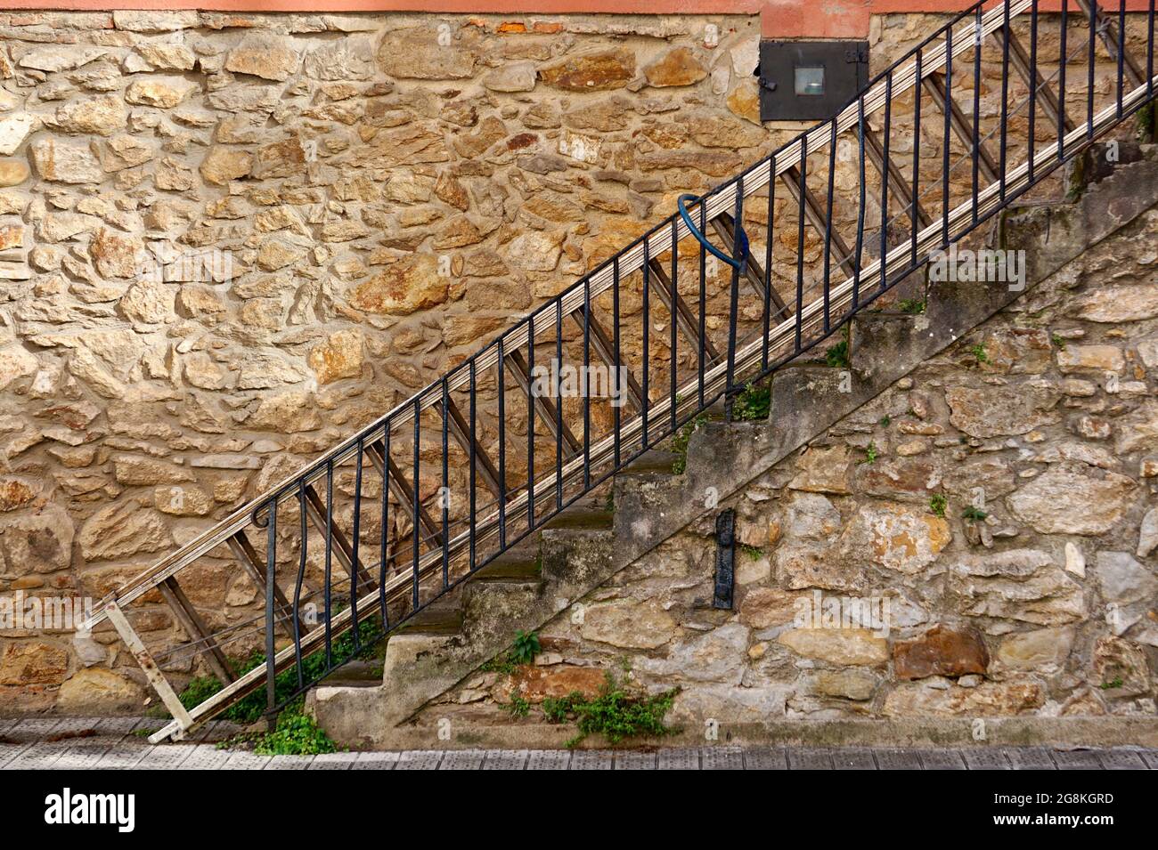 Stairway with a metal handrail and beautiful rocky walls Stock Photo ...