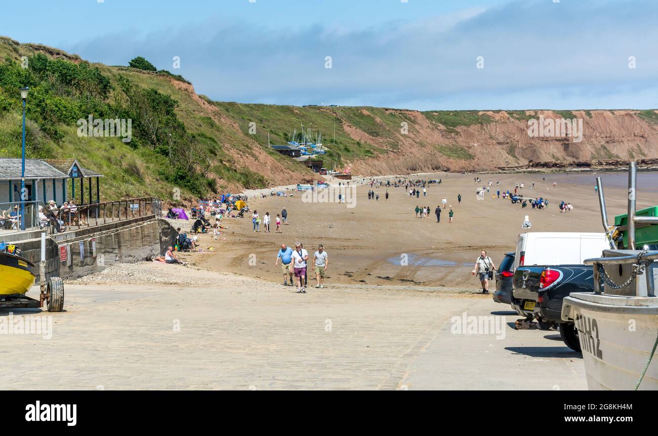 People out walking on a popular beach at Filey in North Yorkshire, UK ...