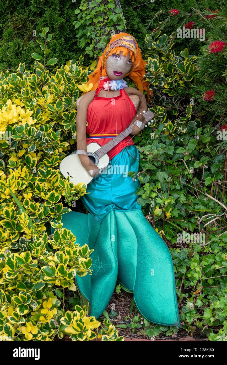 bright colourful mermaid scarecrow with a guitar Stock Photo - Alamy