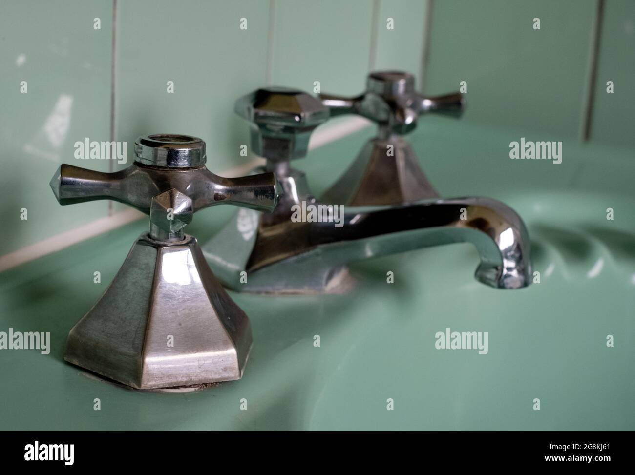 Close up of original green vintage retro 1930s deco wash basin and ...